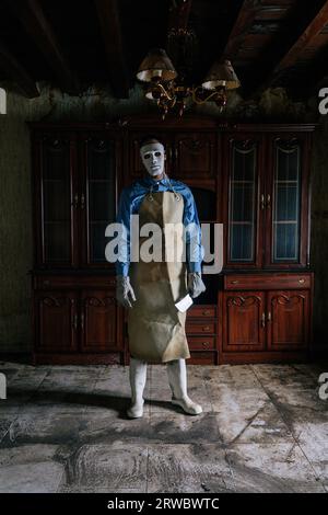 Anonymous terrifying man in butcher costume with apron and knife ...