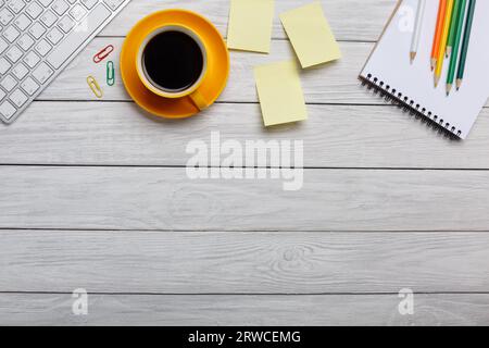 Blank notebook, binder clips, eraser and sharpeners on dark background ...