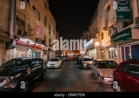 a quiet street at night in Manama, Bahrain, on the Pearling Path, a ...