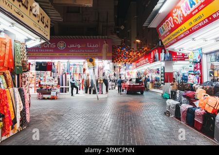 a street full of shops selling clothing, toys and other household items ...