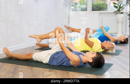 Knees To Chest Pose - Apanasana Stock Photo - Alamy