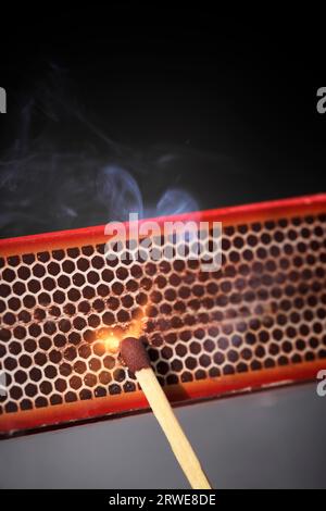 Striking a match against a match box Stock Photo - Alamy