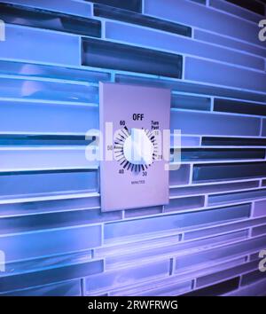 Iconic old-school wall-mounted kitchen appliance timer. Electrical ...