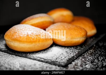 German Krapfen with drizzling glazed sprinkles in black elegant ...