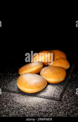 German Krapfen with drizzling glazed sprinkles in black elegant ...