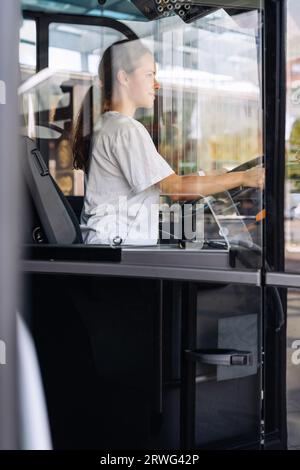Young Caucasian female bus driver using the pos of the bus Stock Photo ...