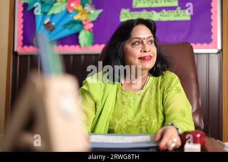 School Principal mam sitting happily, proud of the students of her ...