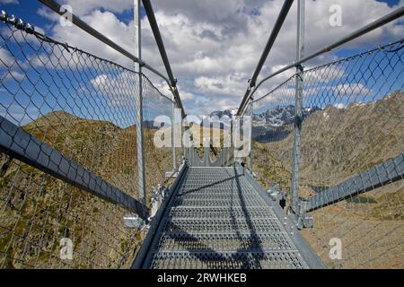 An himalayan pedestrian bridge allows hikers and tourists to access a ...