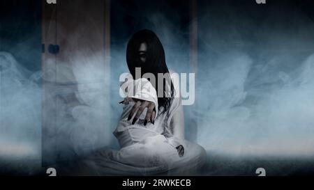 A scary ghost woman crawls on the floor with white smoke background ...