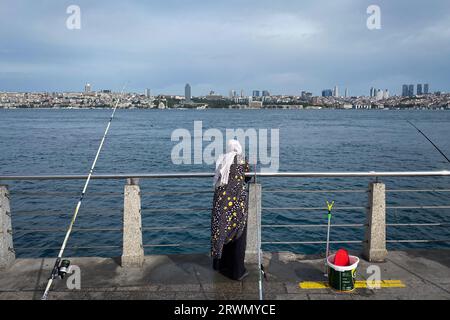 A fisherman fishes in the Bosphorus Strait in Istanbul. (Photo by ...