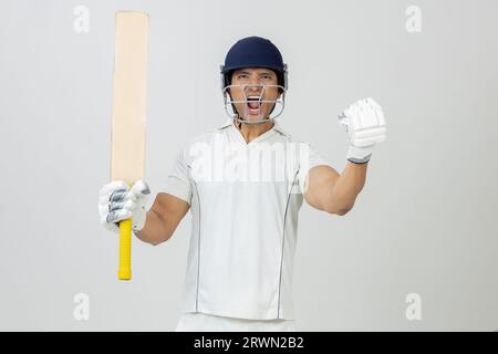 Man In cricket dress with helmet screaming in joy and anger, Cricketer ...