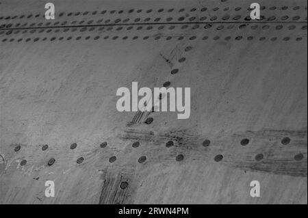 Metallic background with studs. Fragment of an old airplane fuselage ...