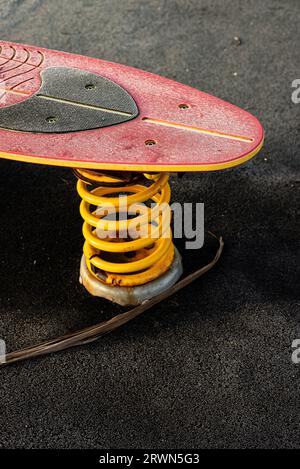 Red and yellow surfboard on springs in frozen playground Stock Photo ...