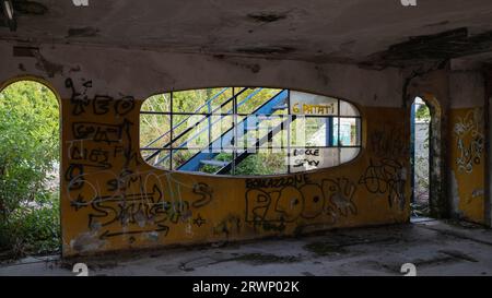 Old swimming pool center full of trash, rubbish, overgrown facility in ...