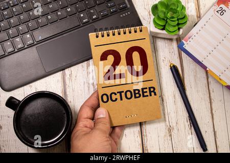 Cube shape calendar for October 20 on wooden surface with empty space ...