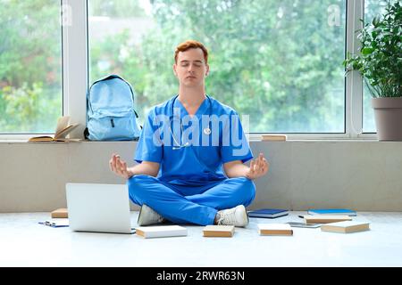 Male medical student meditating at university Stock Photo - Alamy