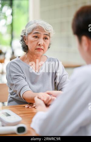 female patient checked heart rate by doctor with stethoscope Stock ...