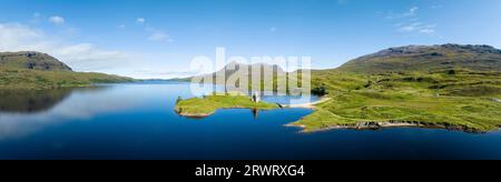 Aerial panorama of the freshwater loch Loch Assynt with the ruins of ...
