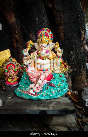 Sculpture of Lord Ganesha beneath a tree, used for worship. Uttarakhand ...