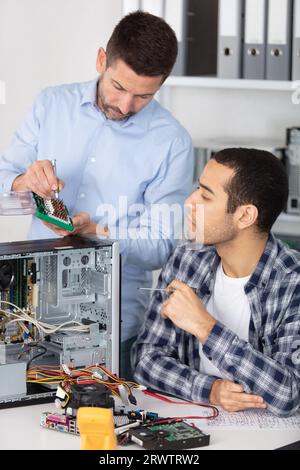 apprentice repairing computer in technical school Stock Photo - Alamy