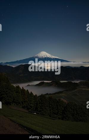 Fuji illuminated by the full moon over the sea of clouds viewed from ...