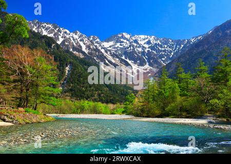 Lingering snow on the clear stream of Azusa River and the Hotaka ...