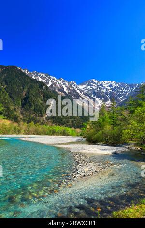 Lingering snow on the clear stream of Azusa River and the Hotaka ...
