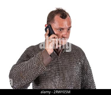 Medieval knight in armor talking on a cell phone. Isolated on white ...