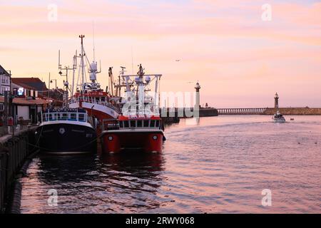 Sunset over pretty Whitby harbour on the North Yorkshire coast, UK ...