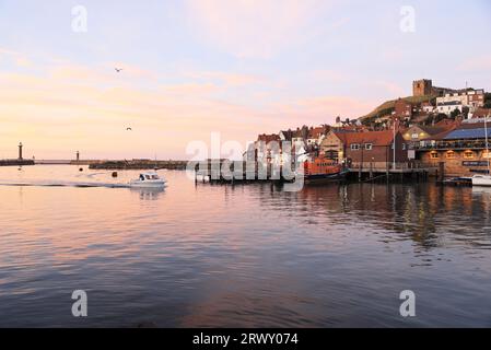 Sunset over pretty Whitby harbour on the North Yorkshire coast, UK ...