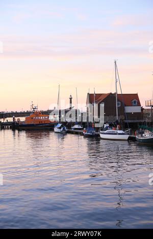 Sunset over pretty Whitby harbour on the North Yorkshire coast, UK ...