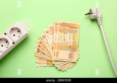 Bulgarian lev banknotes with plug and power socket on green background ...