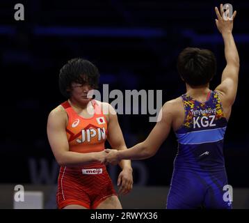 Kyrgyz Aisuluu Tynybekova, blue, and Sakura Motoki of Japan compete in ...