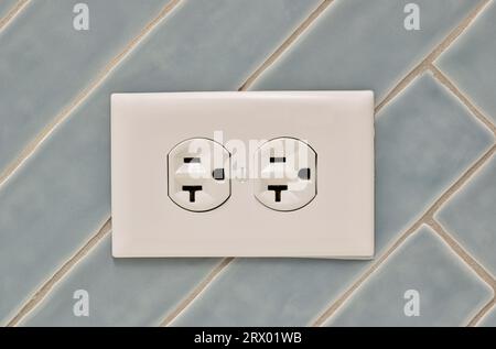 Twin power outlet duplex socket on a tiled wall, USA NEMA 5-15 ...