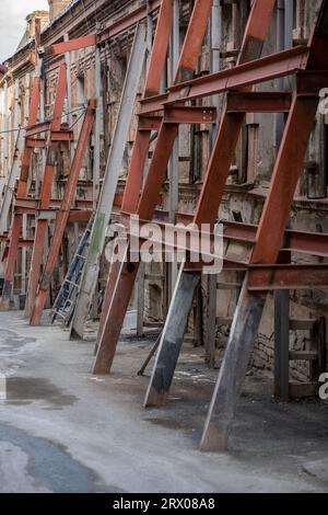 reconstruction of city building. metal scaffolding with green ...