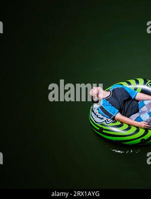 Floating down a river on a tube Stock Photo - Alamy