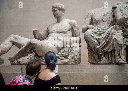 Visitors observe the Elgin Marbles, a collection of Greek sculptures from the Parthenon in ...