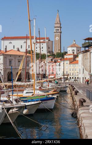 Evening atmosphere at the harbour of Piran, in the back St. George's ...