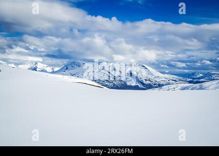 Photo of countryside and Tromsdalstinden mountain covered in snow ...