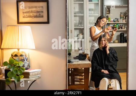 Home visiting hairdresser, a woman has a hairdressing appointment at ...