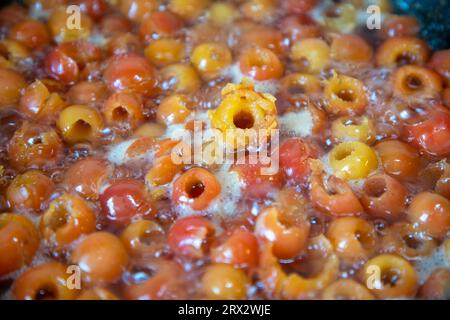 Boiling begonia fruits in the pot Stock Photo - Alamy