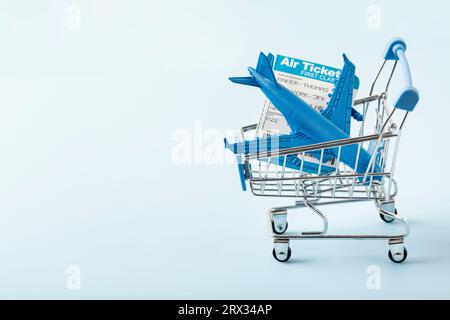 Plane in a shopping trolley. Season travel concept background, toned ...