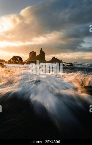 Beautiful golden sunset, north Tenerife, Atlantic Ocean, Almaciga black ...