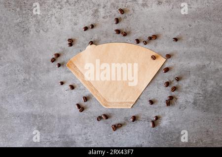 coffee paper filter on grey background with coffee beans around Stock ...
