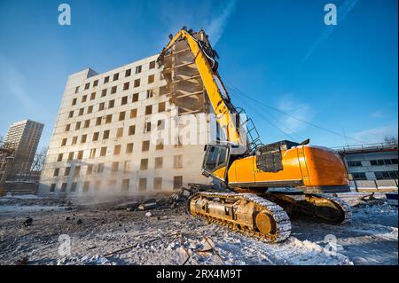 Demolition of old residential building. Crawler excavator demolishing ...