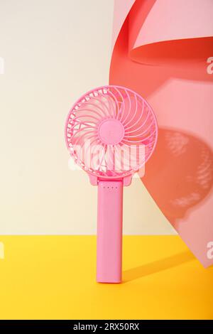 Mini pink electric fan on beige background Stock Photo - Alamy