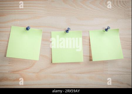 Three green paper notes mockup pinned to wooden bulletin board. sticky ...