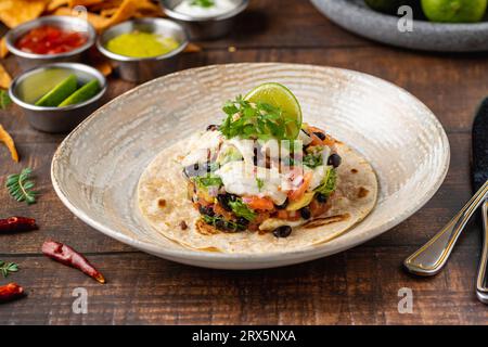 Fish ceviche toast on porcelain plate on wooden table. Spanish name ...