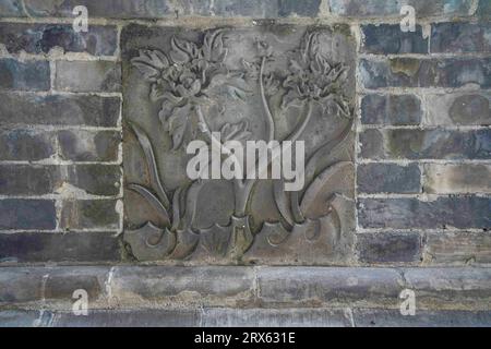 Brick carvings on the wall of the flower bed of the Salar people Museum ...
