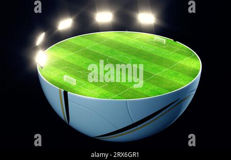 A soccer ball split in half revealing a marked green grass football ...